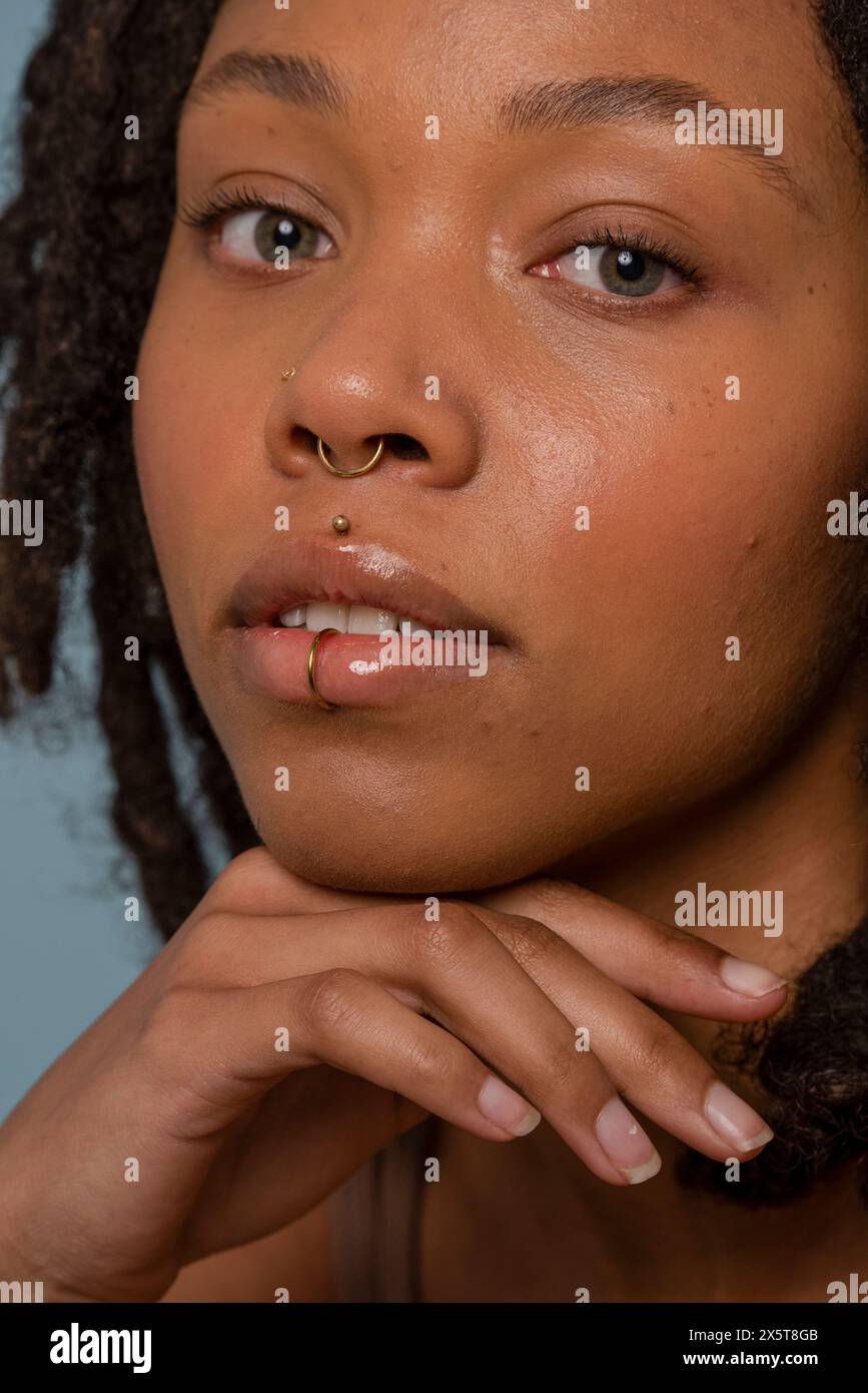 Portrait of young woman wearing face piercing Stock Photo - Alamy