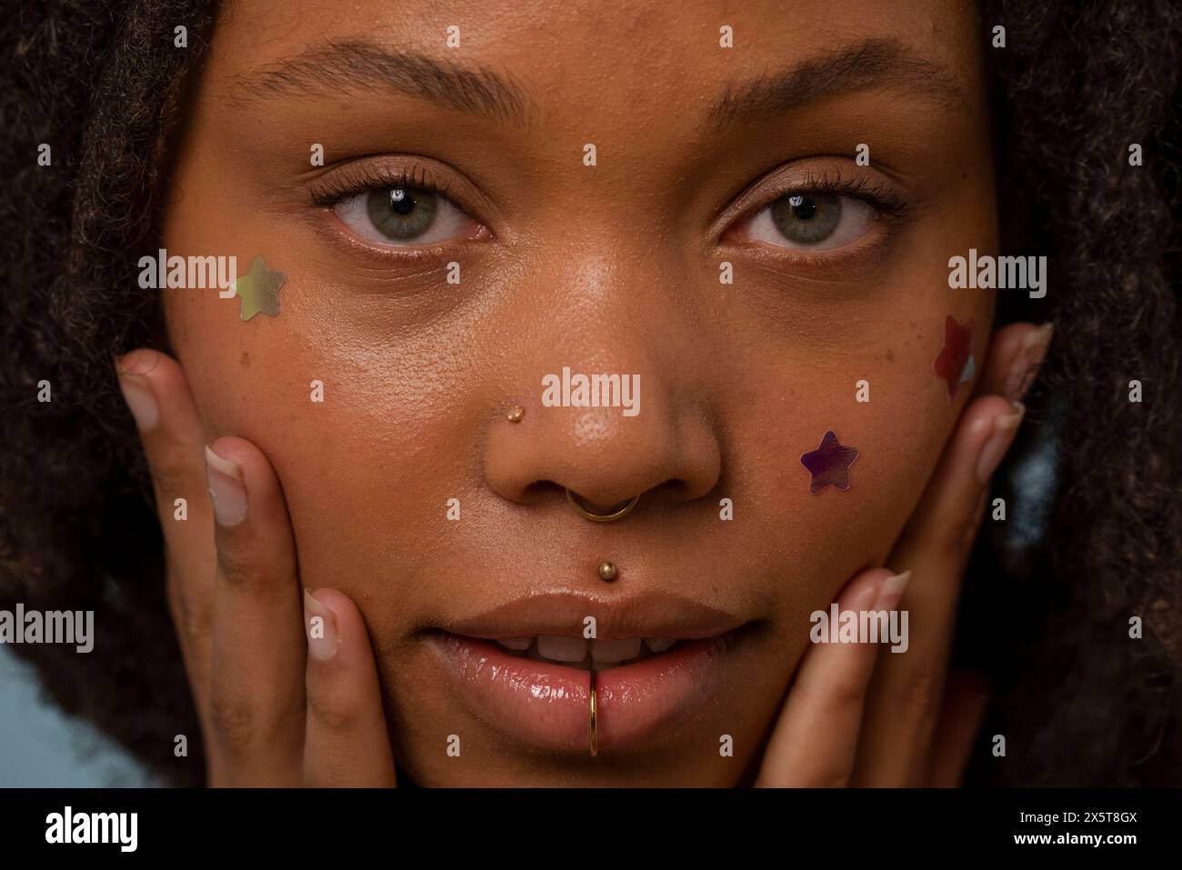 Portrait of young woman wearing star stickers on face Stock Photo - Alamy