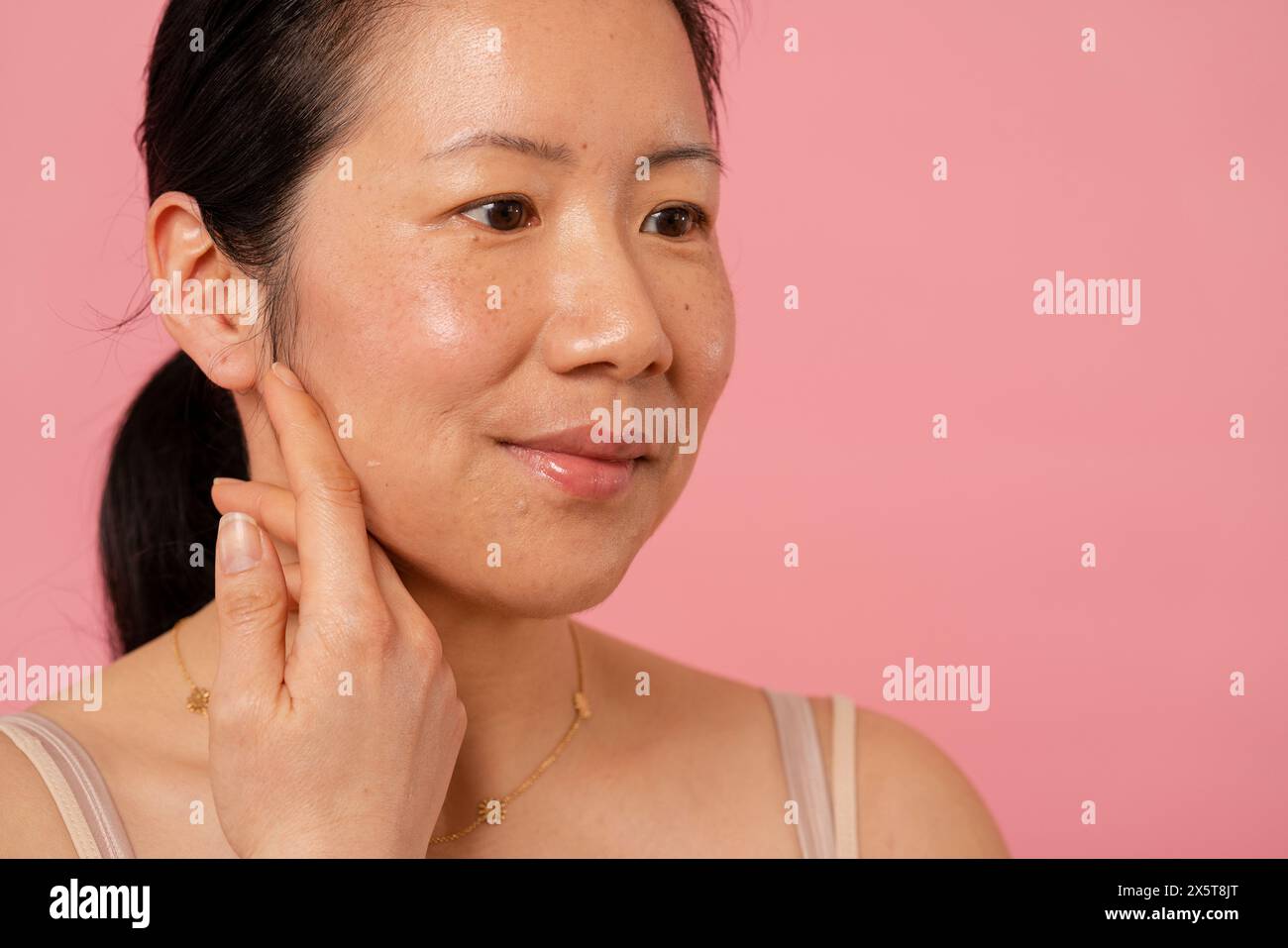 Beautiful woman touching pink hi-res stock photography and images - Alamy