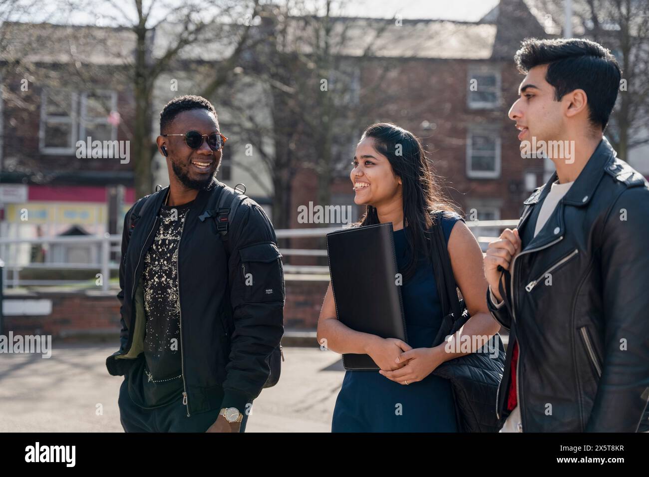 Group young friends walking talking hi-res stock photography and images ...