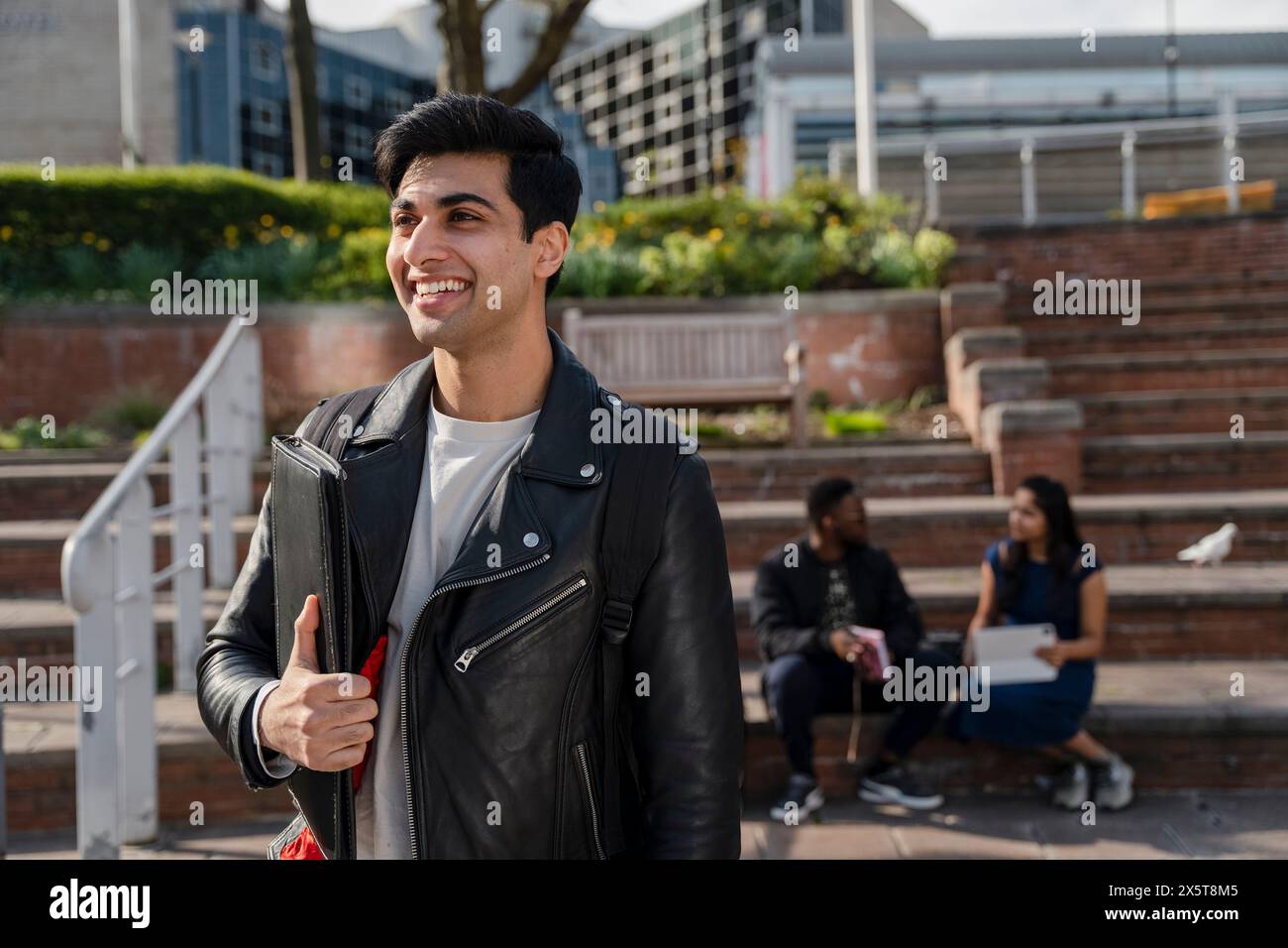 Smiling male student on campus Stock Photo - Alamy