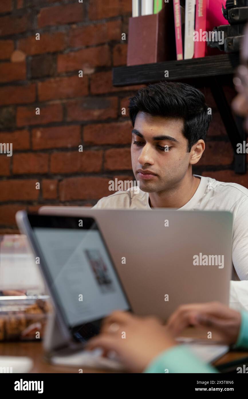 Male student laptop library hi-res stock photography and images - Alamy