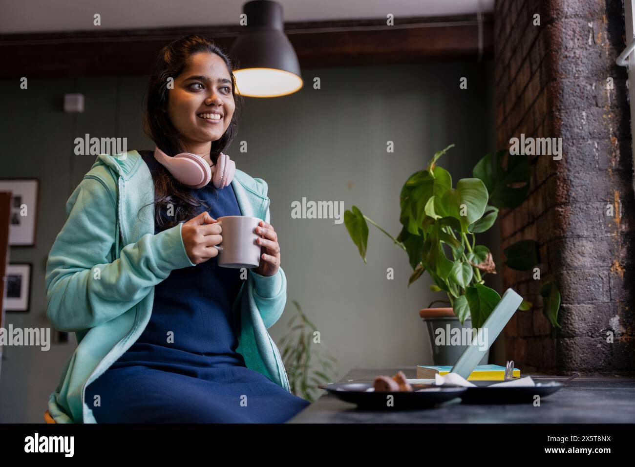 Female student drinking tea while studying Stock Photo - Alamy