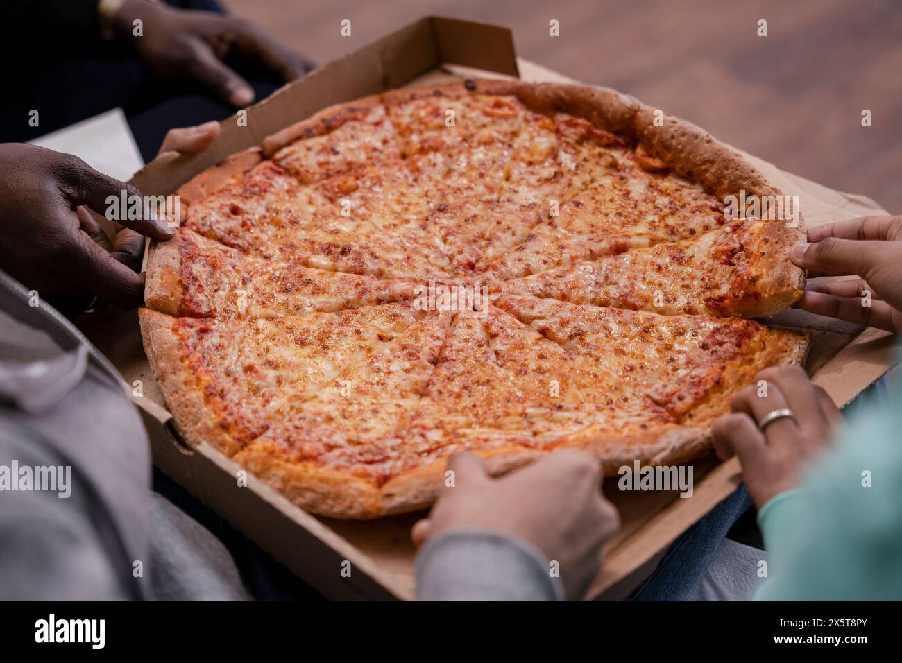 Indian group eating pizza hi-res stock photography and images - Alamy