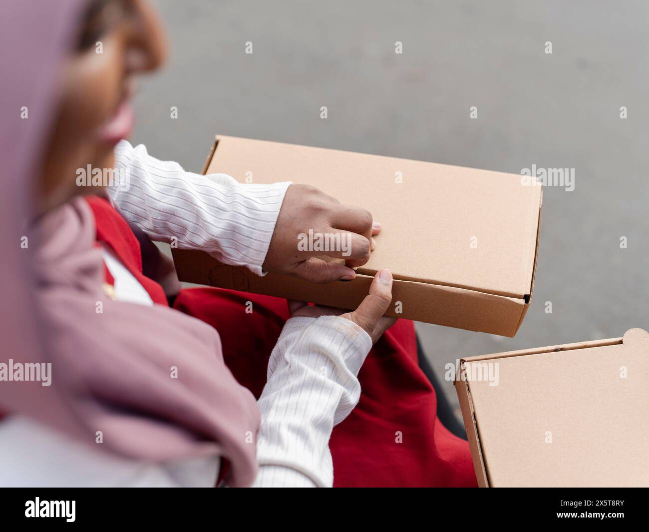 Woman opening pizza box in park during lunch Stock Photo - Alamy