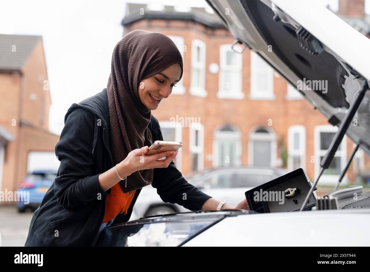 Asian woman open car hood hi-res stock photography and images - Alamy