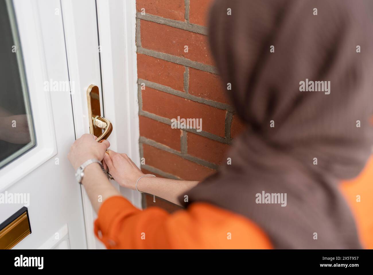 Woman by house hi-res stock photography and images - Alamy