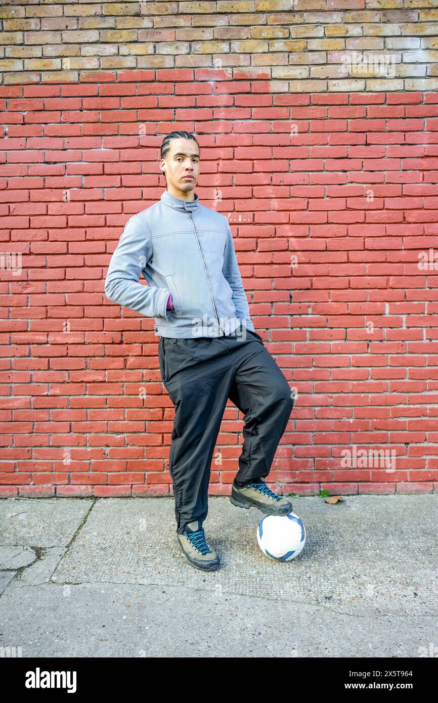 Portrait of young man with football Stock Photo - Alamy
