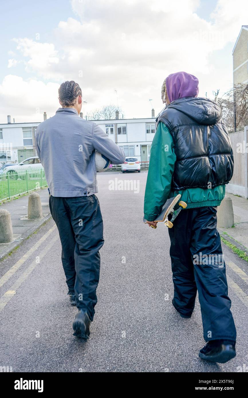 Two male friends walking hi-res stock photography and images - Alamy