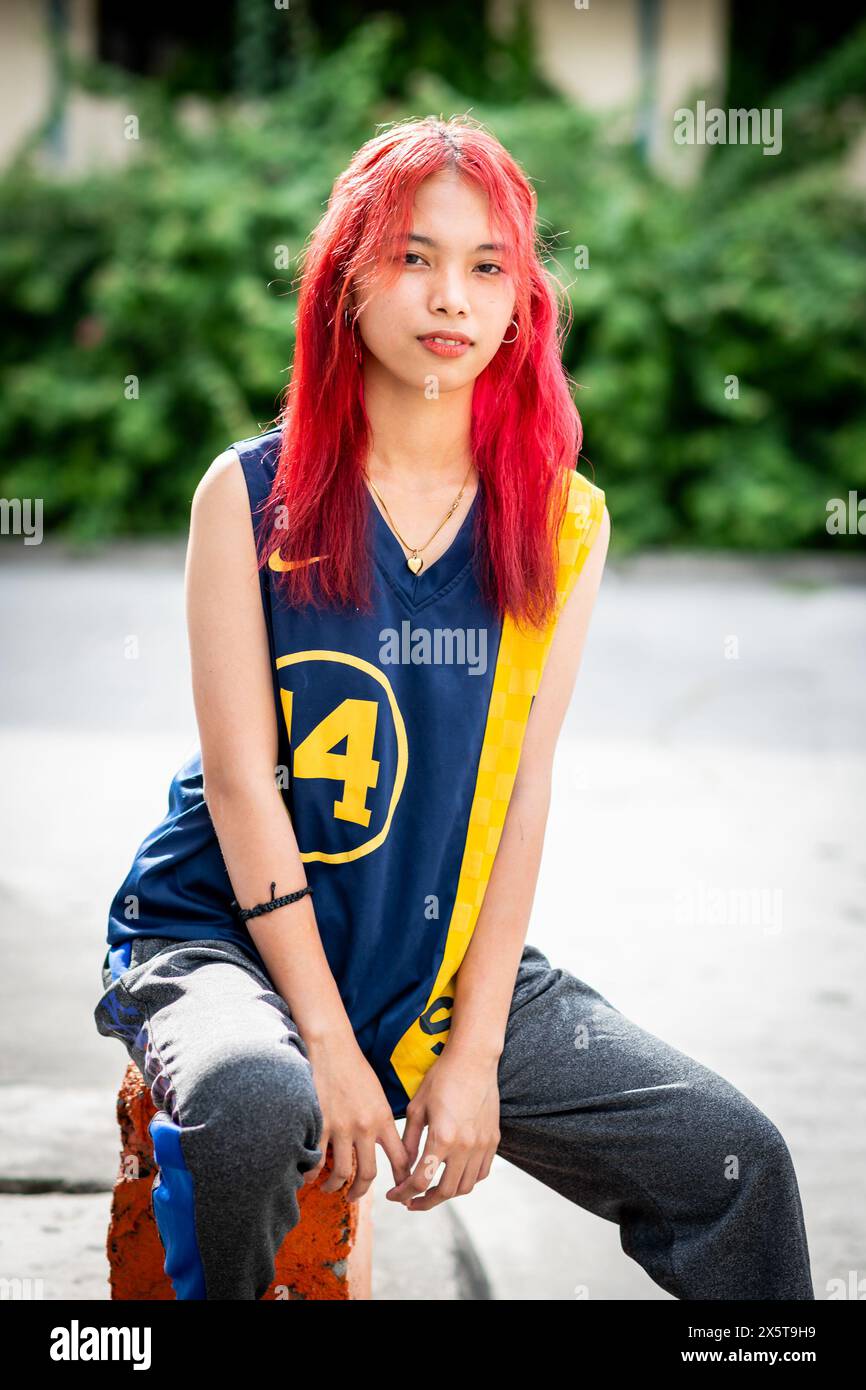 A Beautiful Young Filipino Girl With Red Hair Poses Outside Her Home In Angeles City The