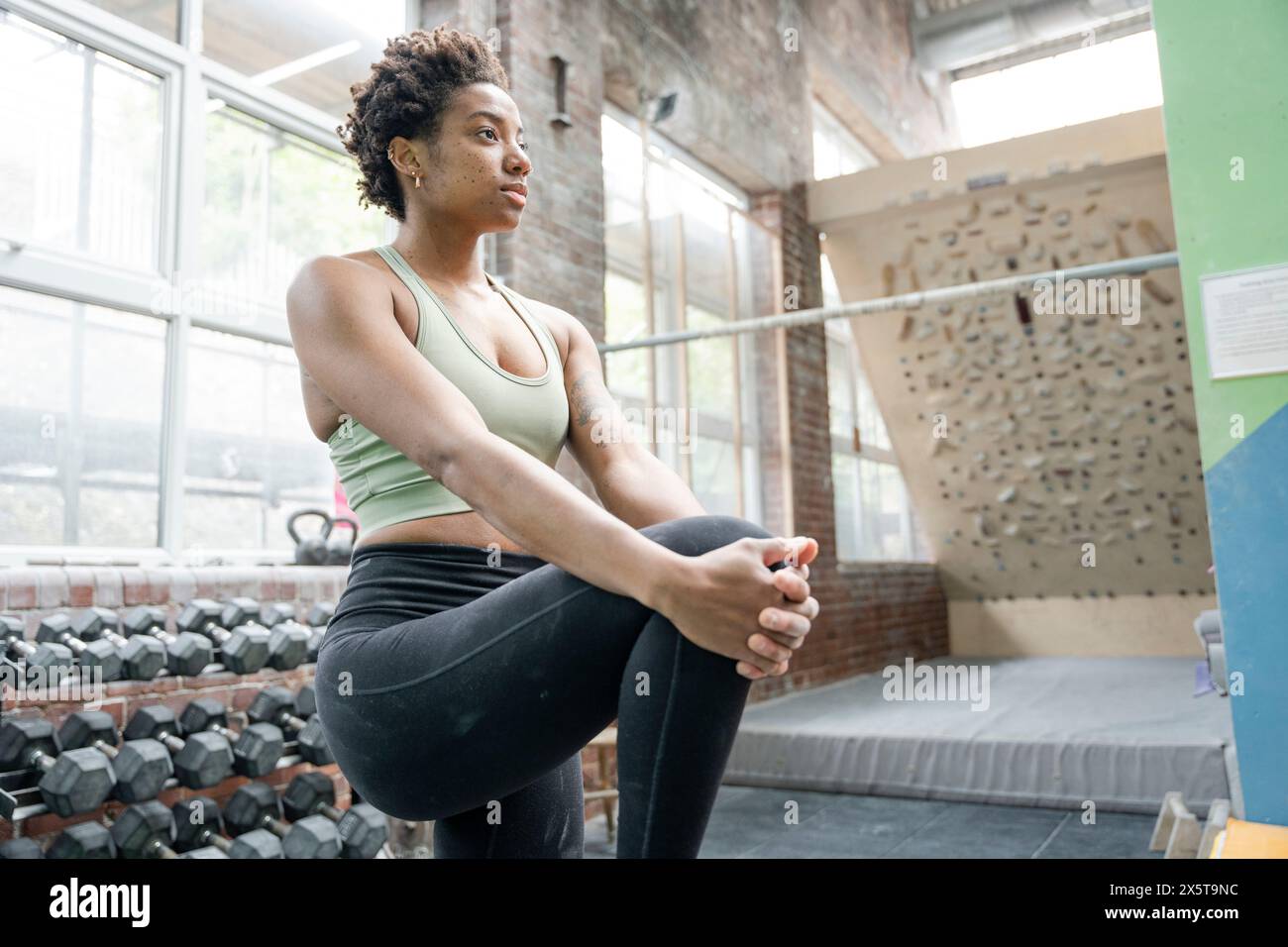 Woman stretching legs in gym before training Stock Photo - Alamy