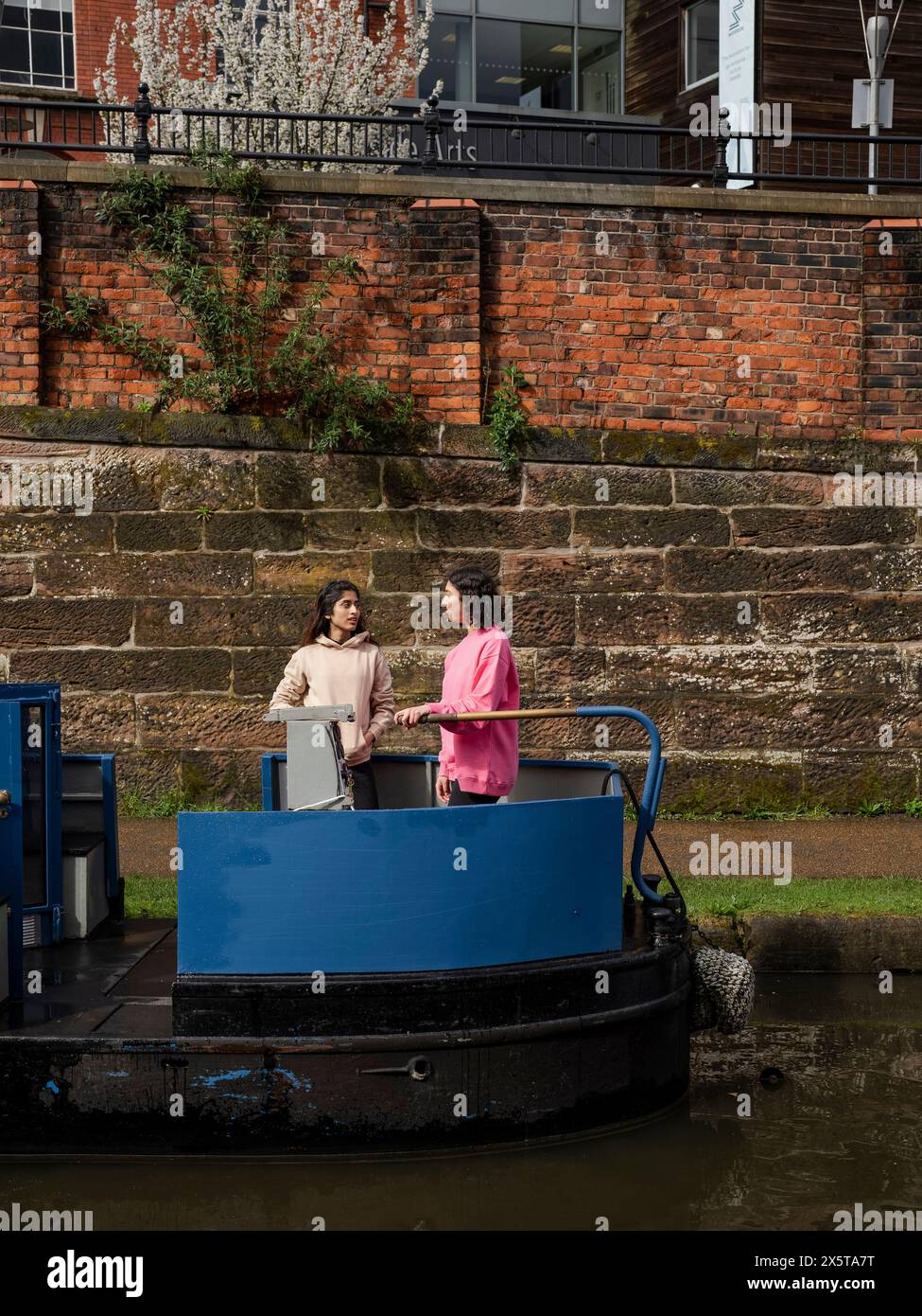 Two women standing by rudder on boat Stock Photo - Alamy