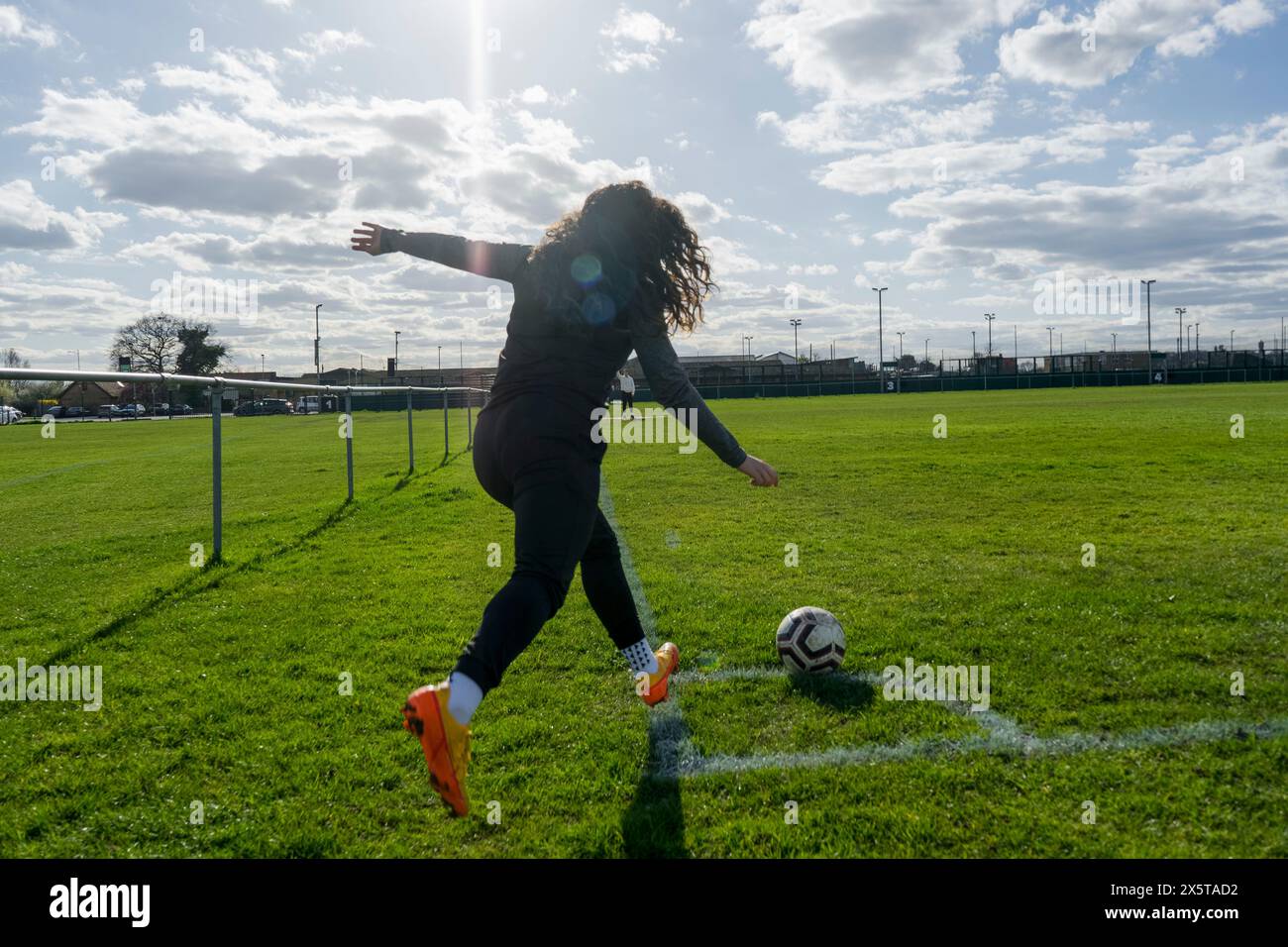 Young woman taking corner kick Stock Photo - Alamy