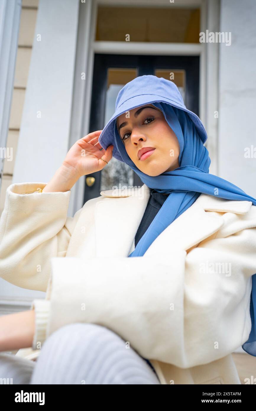 Young woman wearing hijab and bucket hat Stock Photo - Alamy