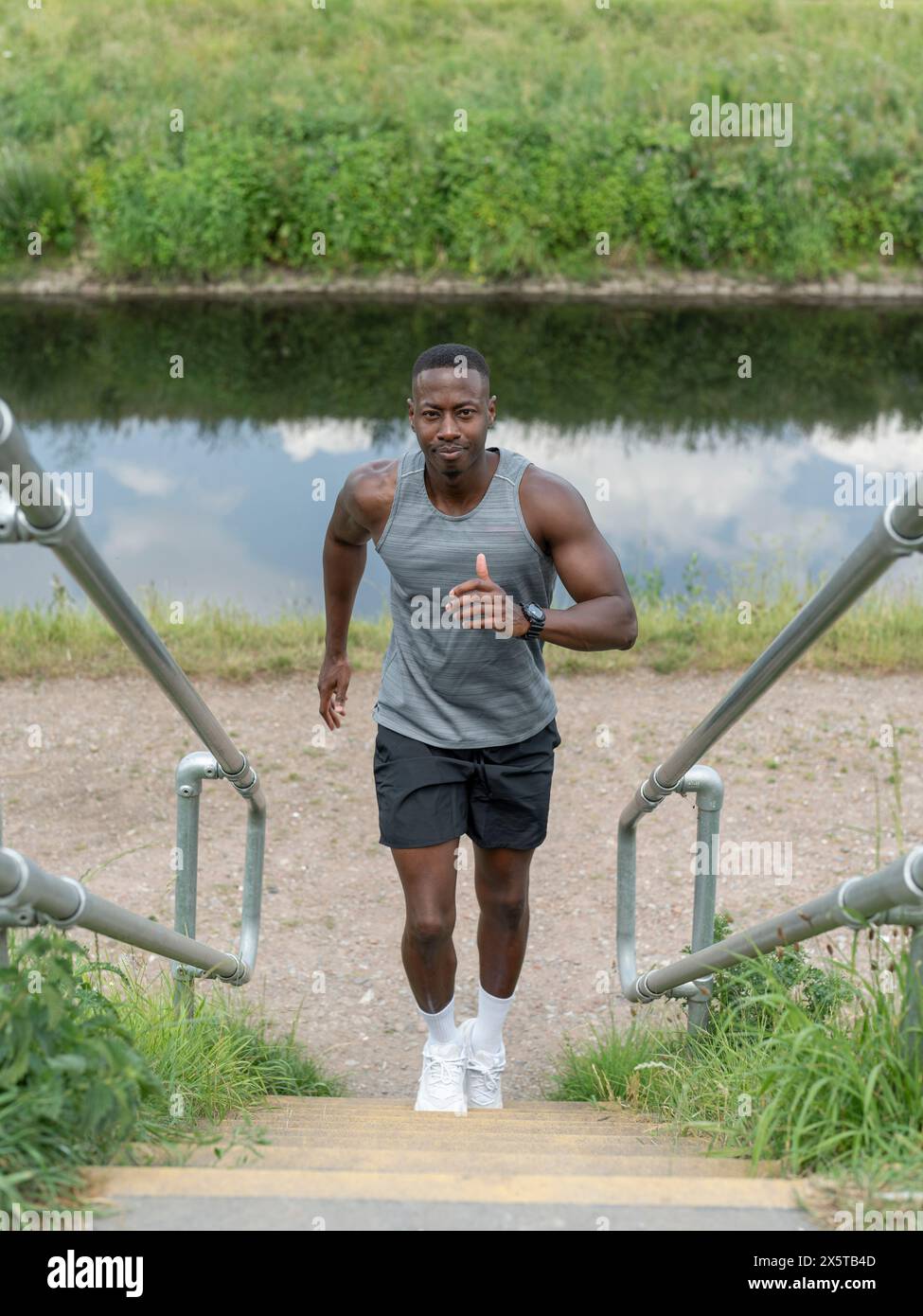 Black man running up stairs hi-res stock photography and images - Alamy