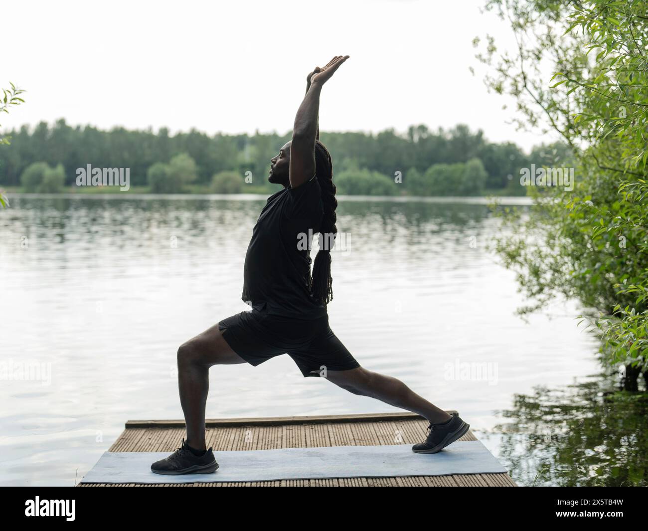 Person training yoga outdoors man hi-res stock photography and images ...