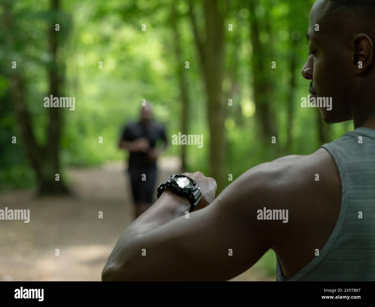 Man jogging in forest and measuring time Stock Photo - Alamy