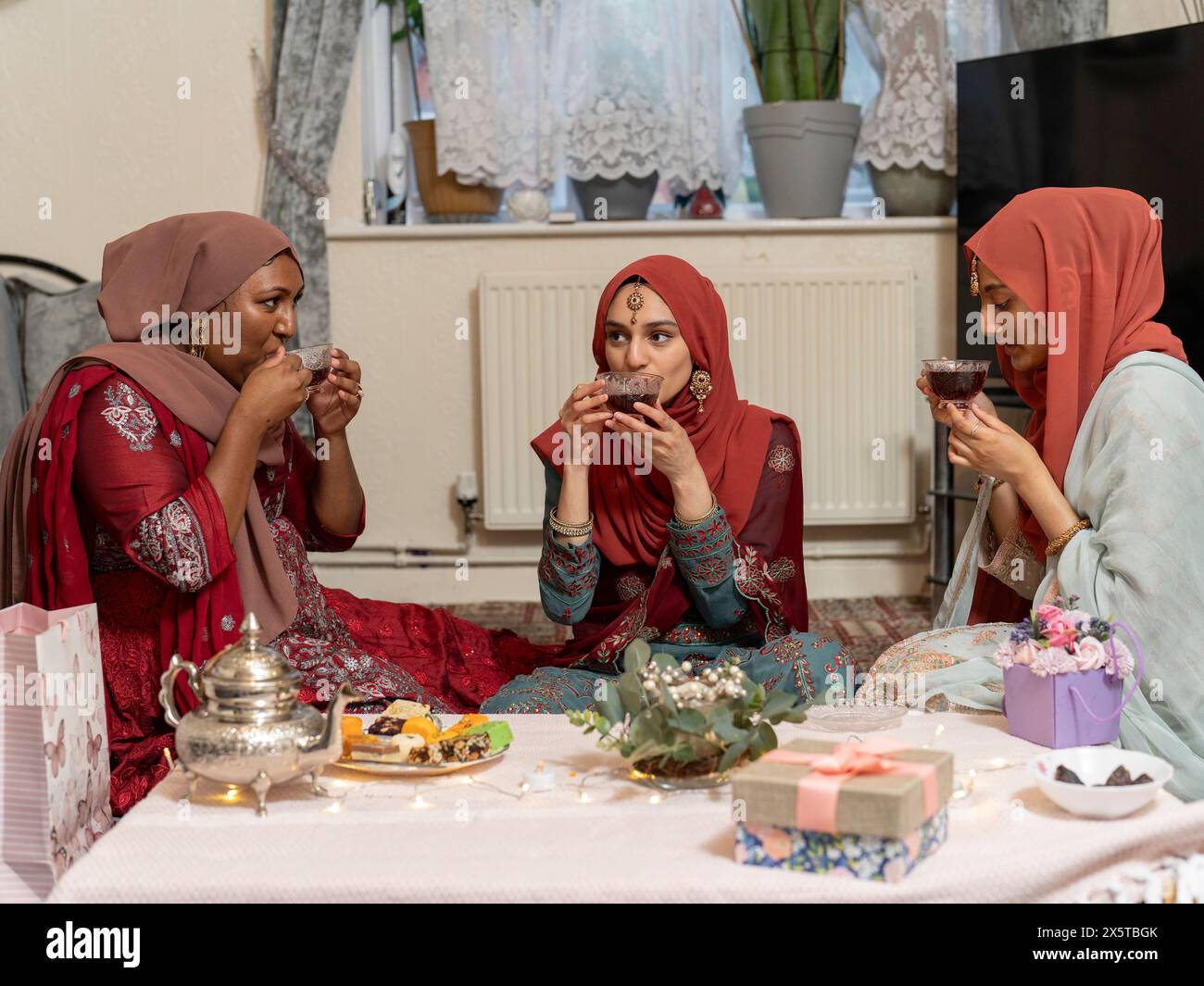 Women having tea during Ramadan celebration at home Stock Photo - Alamy