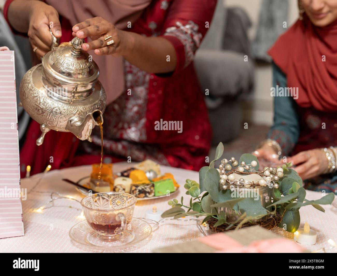 Woman pouring tea during Ramadan celebration at home Stock Photo - Alamy