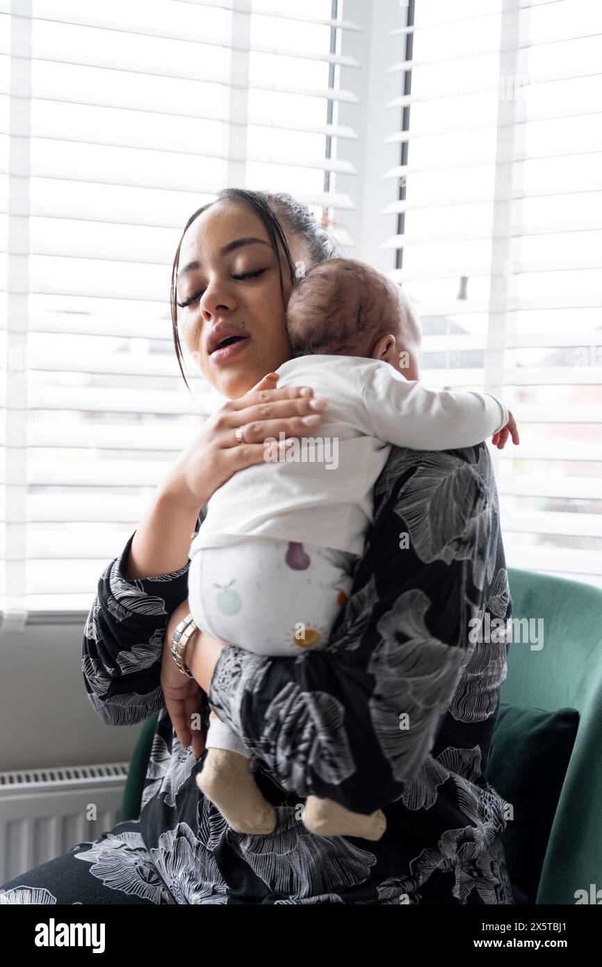 Mother embracing baby girl hi-res stock photography and images - Alamy
