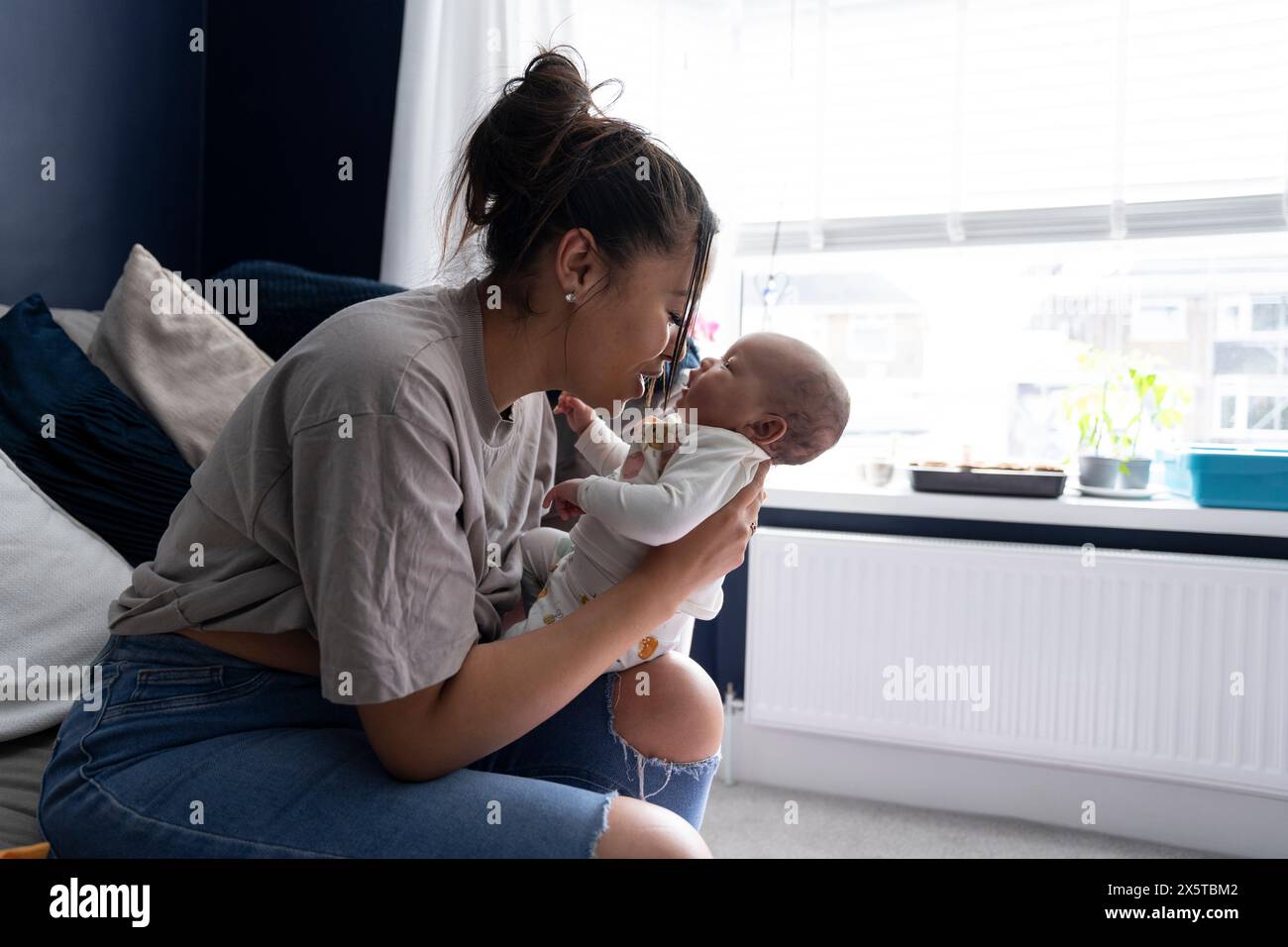 Mother carrying baby girl hi-res stock photography and images - Alamy