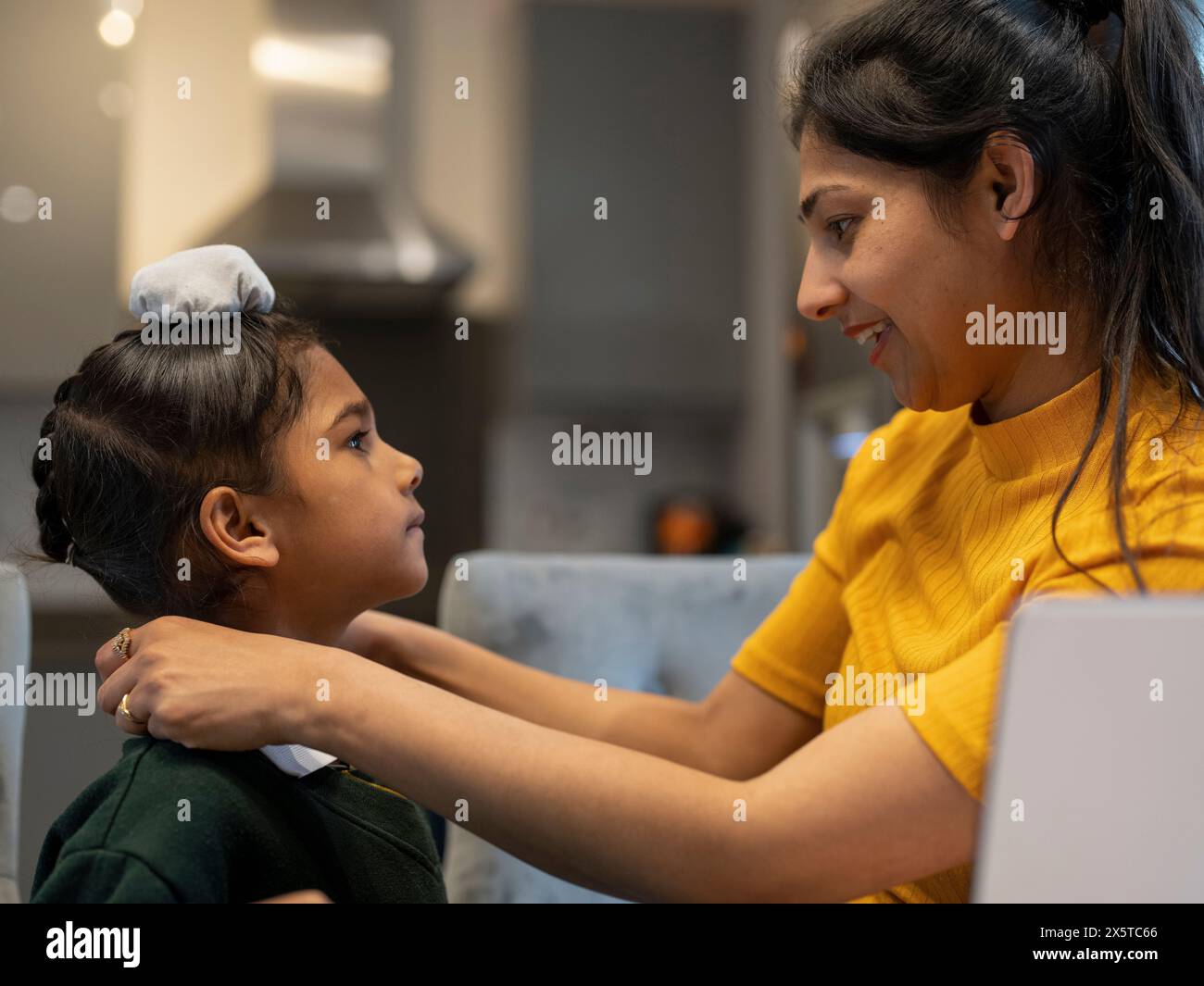 Mother helping son (6-7) get ready for school Stock Photo - Alamy