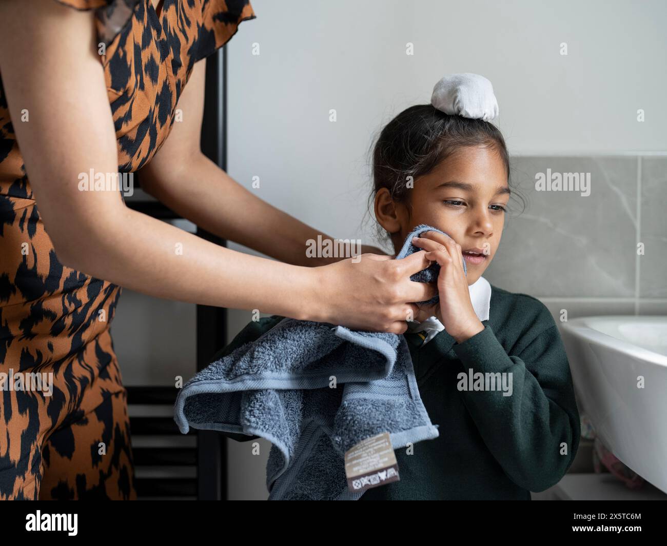 Mother helping son (6-7) dry face with towel Stock Photo - Alamy