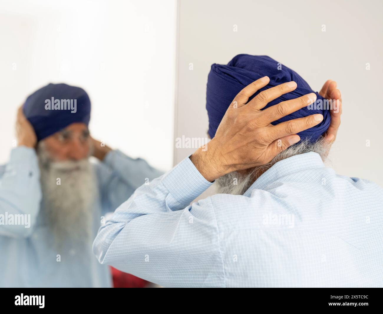 Senior man wrapping turban around head Stock Photo - Alamy
