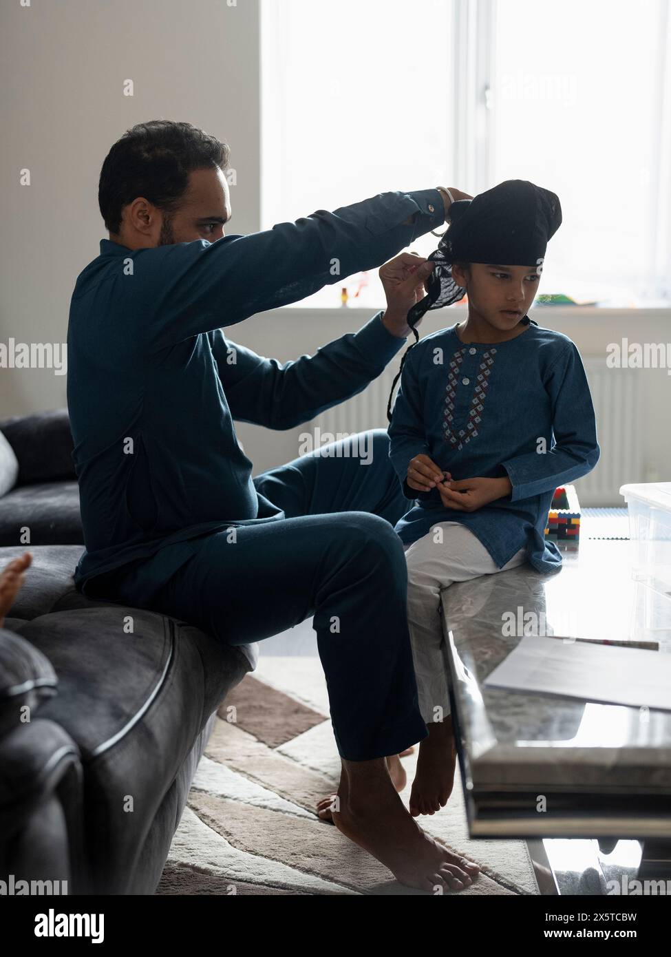 Father wrapping turban around sons head (6-7 Stock Photo - Alamy