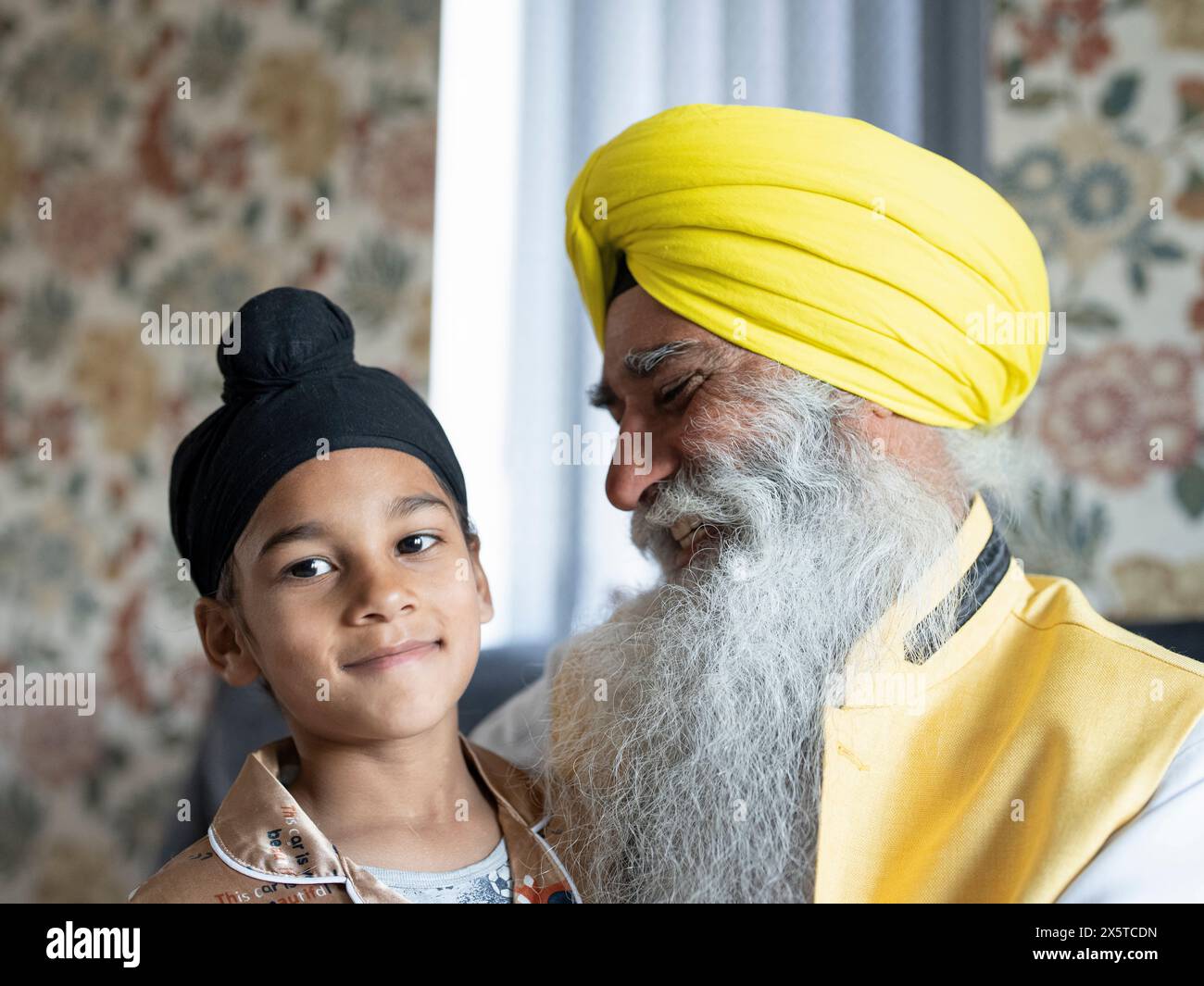 Smiling grandfather and grandson (6-7) in traditional clothing Stock ...