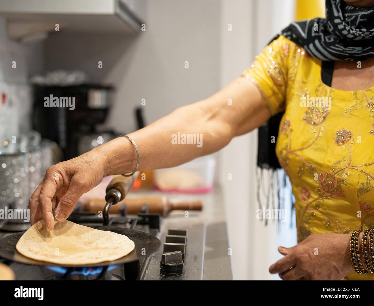 Indian woman cooking traditional bread hi-res stock photography and ...