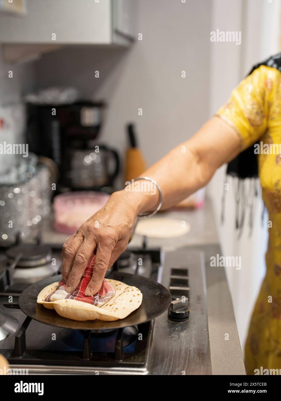 Indian woman cooking traditional bread hi-res stock photography and ...