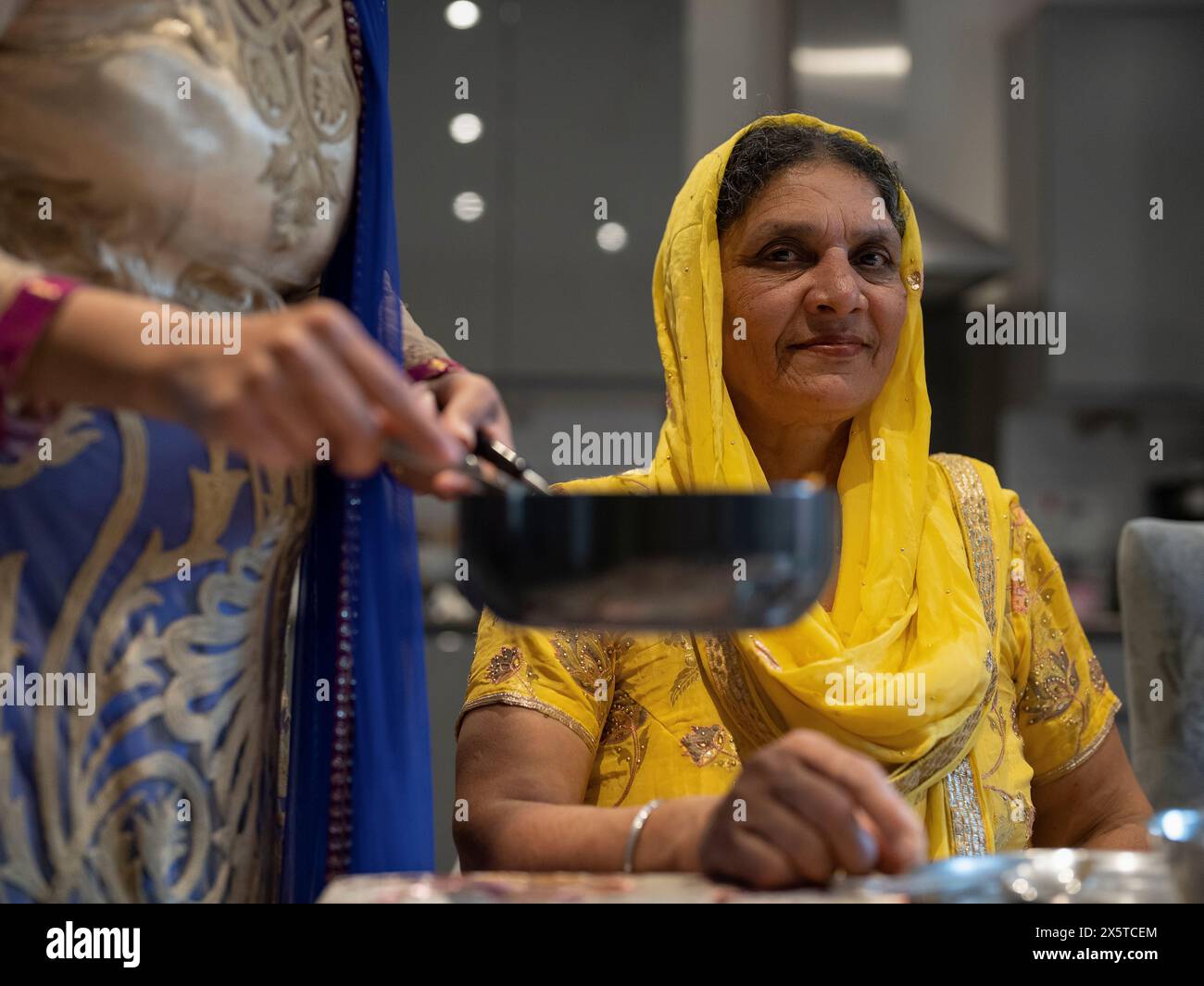 Family in traditional clothing eating meal at home Stock Photo - Alamy