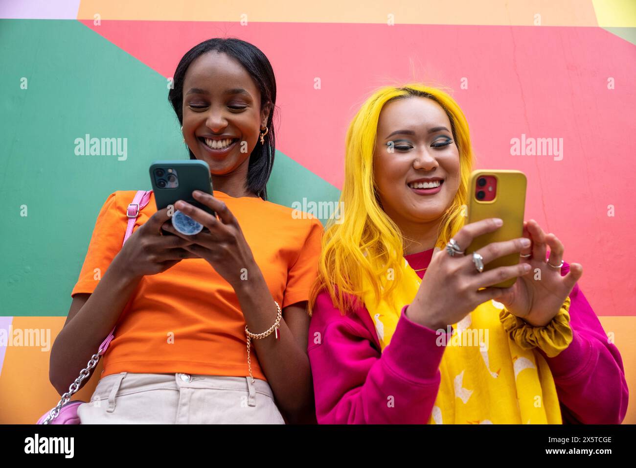 Young female friends using hi-res stock photography and images - Alamy