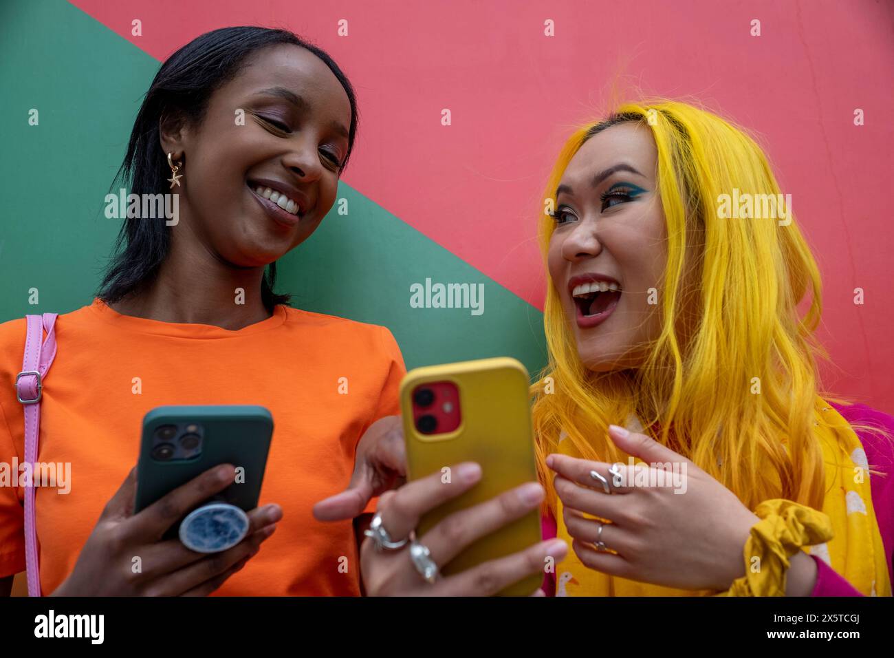 Young female friends using hi-res stock photography and images - Alamy