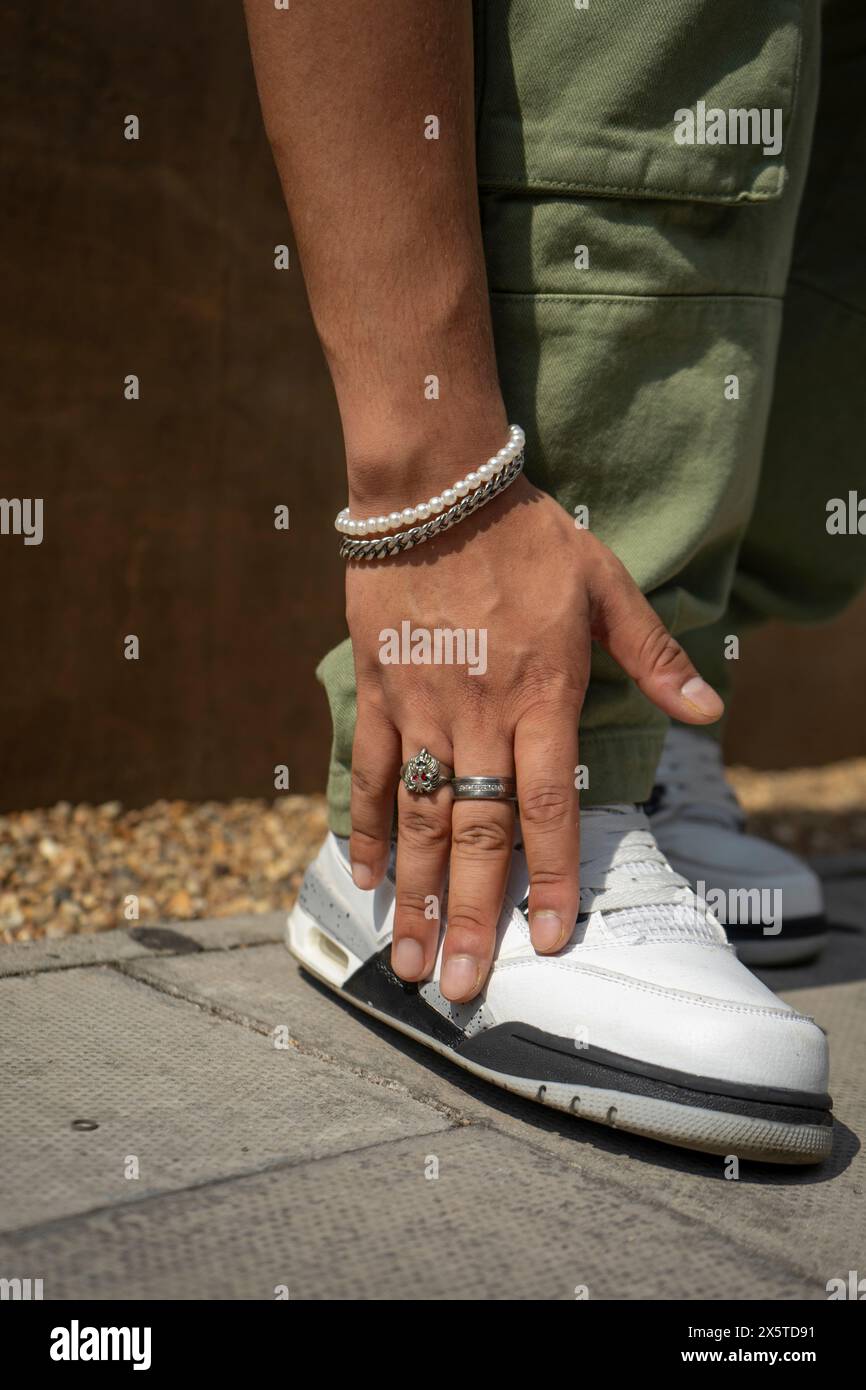Man touching white shoe Stock Photo - Alamy