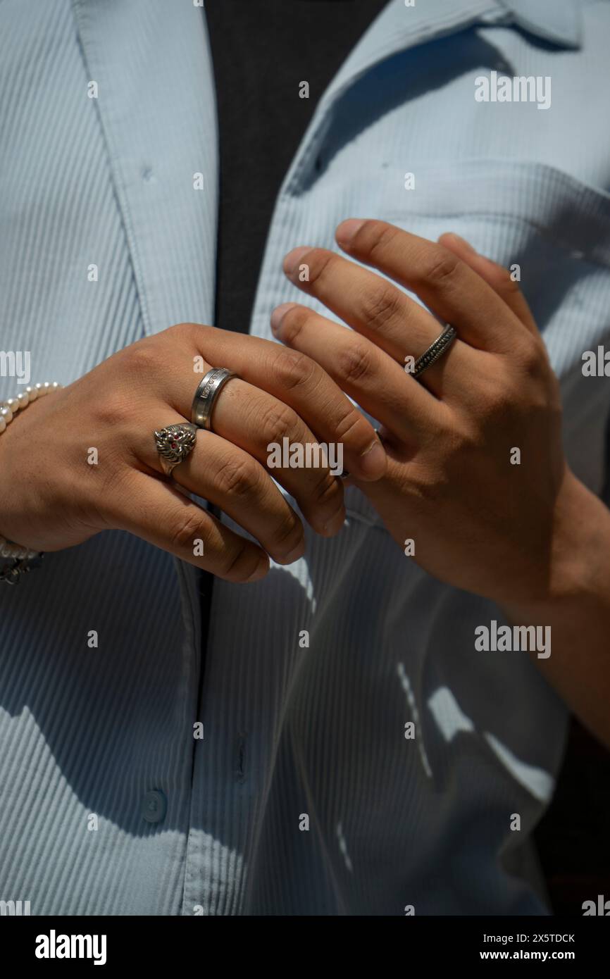 Man wearing bracelets and rings Stock Photo - Alamy