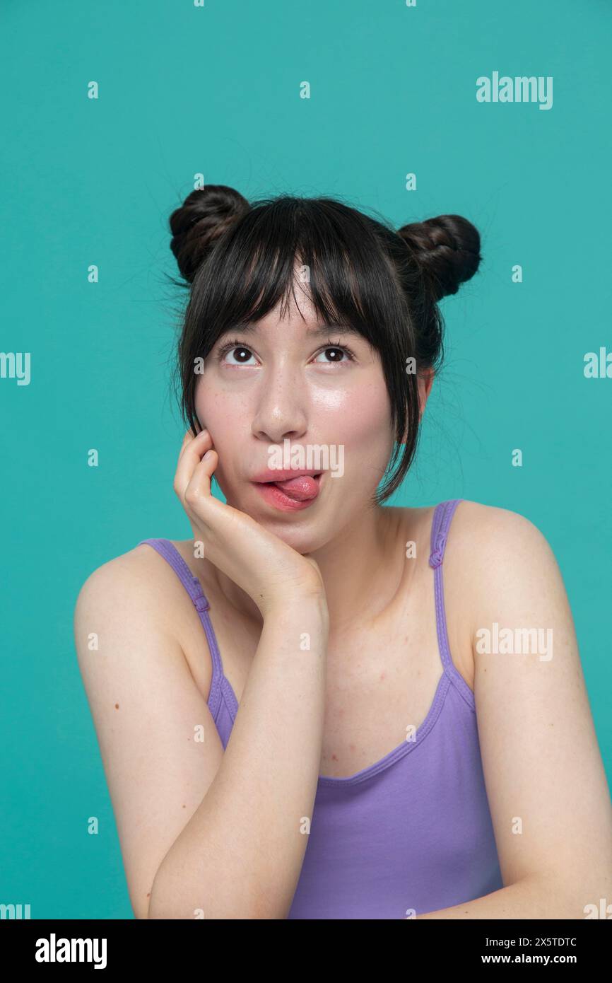 Studio portrait of girl making faces Stock Photo - Alamy