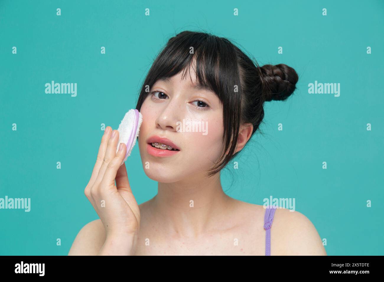 Studio portrait of girl cleaning face Stock Photo - Alamy