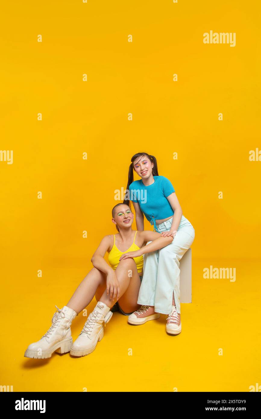 Studio portrait of smiling stylish friends Stock Photo - Alamy