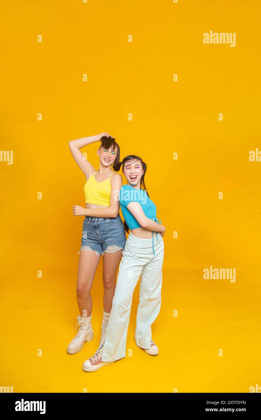 Studio portrait of smiling stylish friends Stock Photo - Alamy