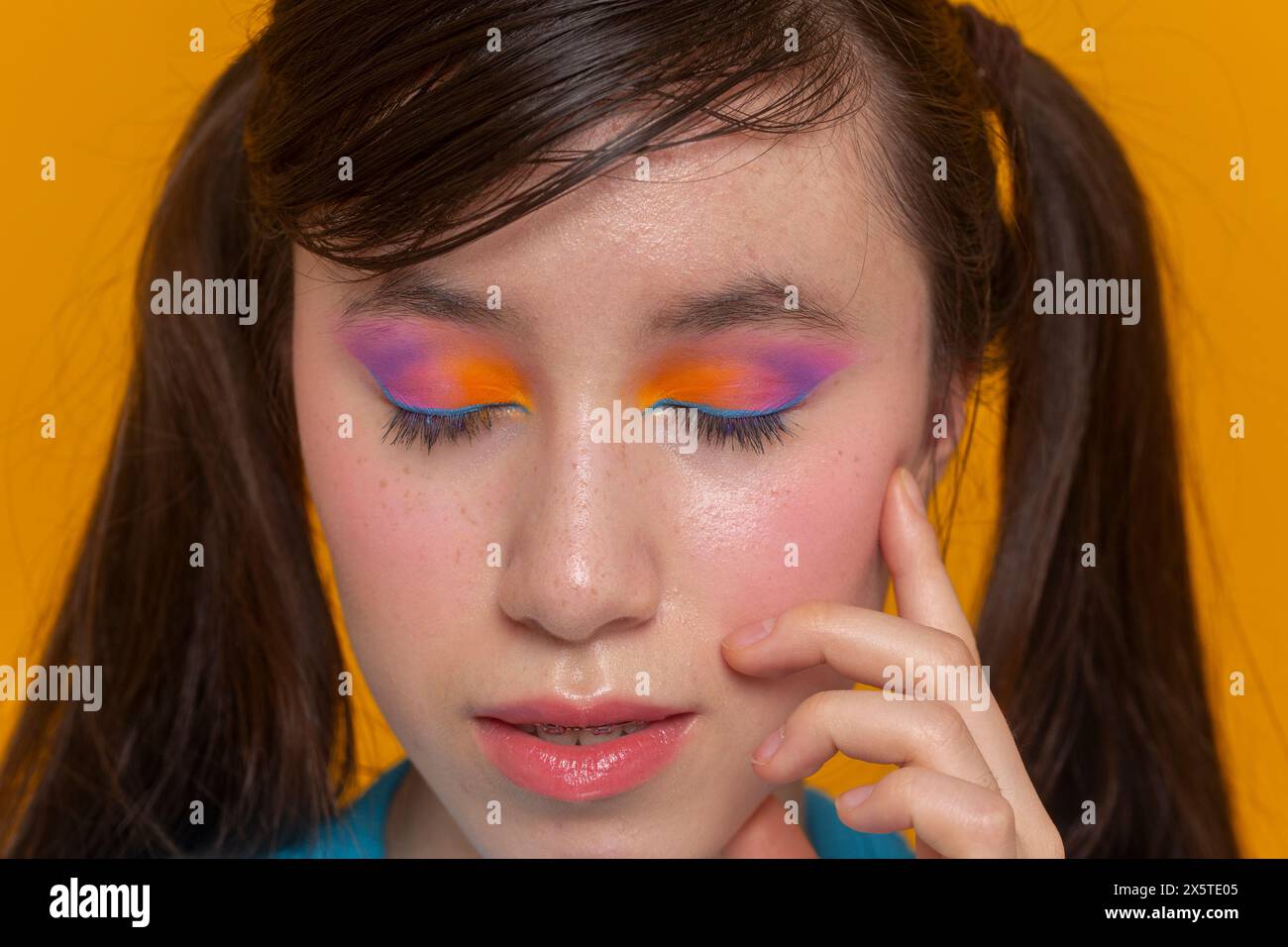 Studio portrait of girl with colorful make-up Stock Photo - Alamy