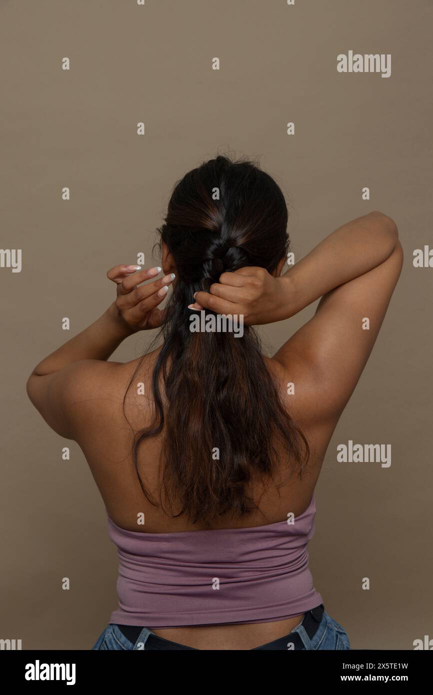 Rear view of woman braiding hair Stock Photo - Alamy