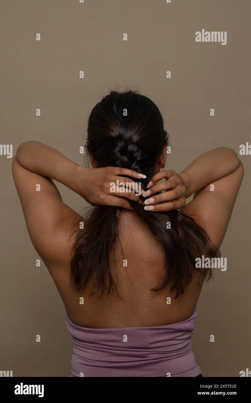Rear view of woman braiding hair Stock Photo - Alamy