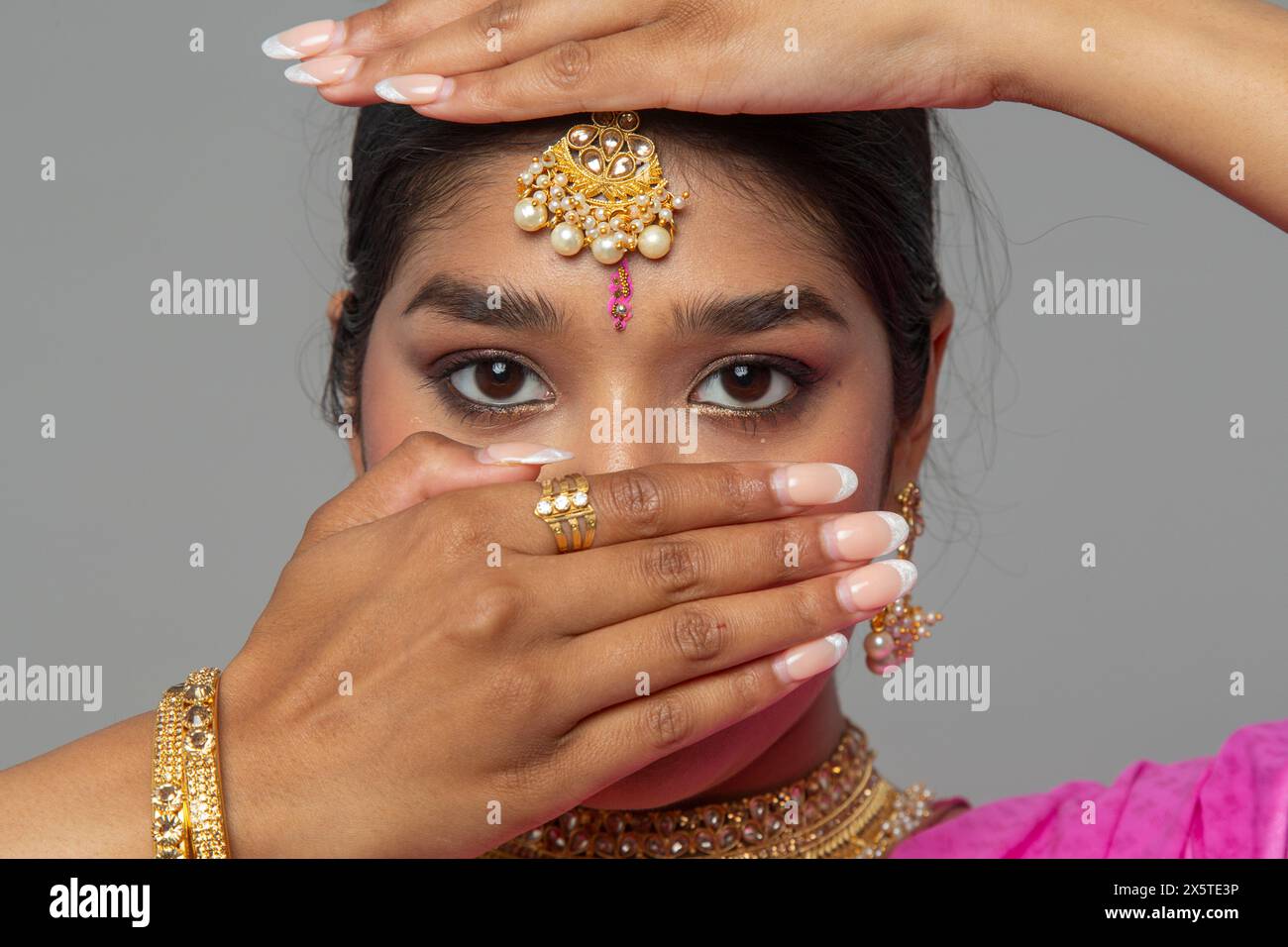 Studio portrait of woman wearing traditional Indian gold jewelry Stock ...