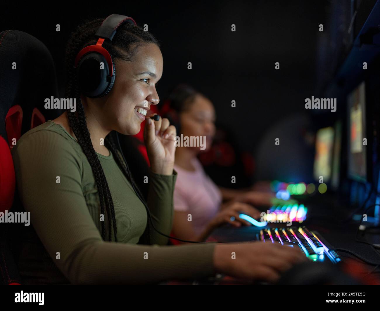 Friends playing video games in gaming club Stock Photo - Alamy