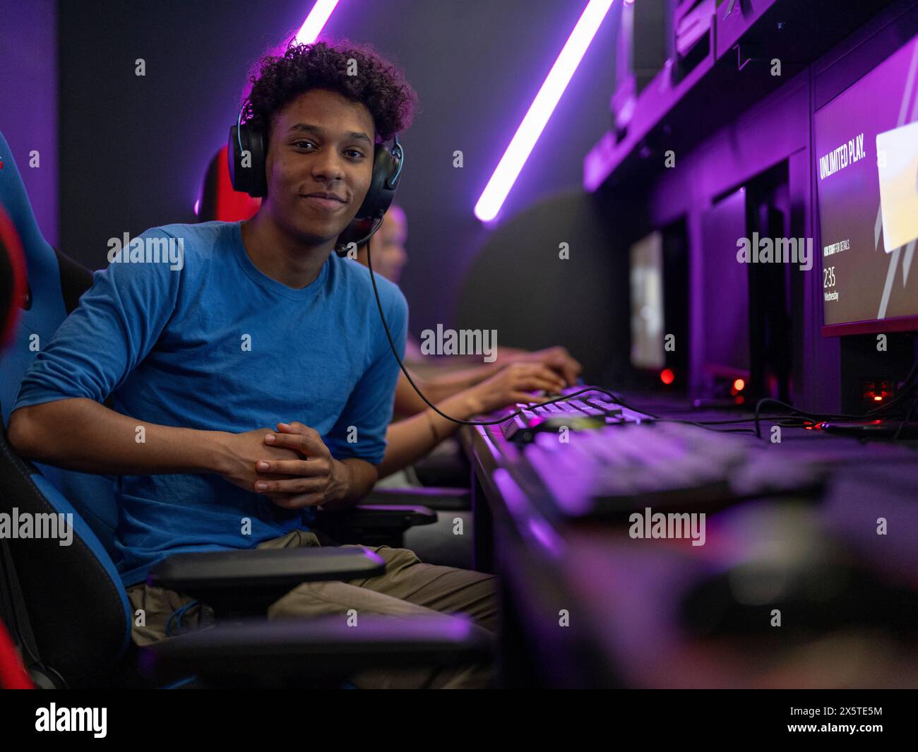 Portrait of young man playing video games in gaming club Stock Photo ...