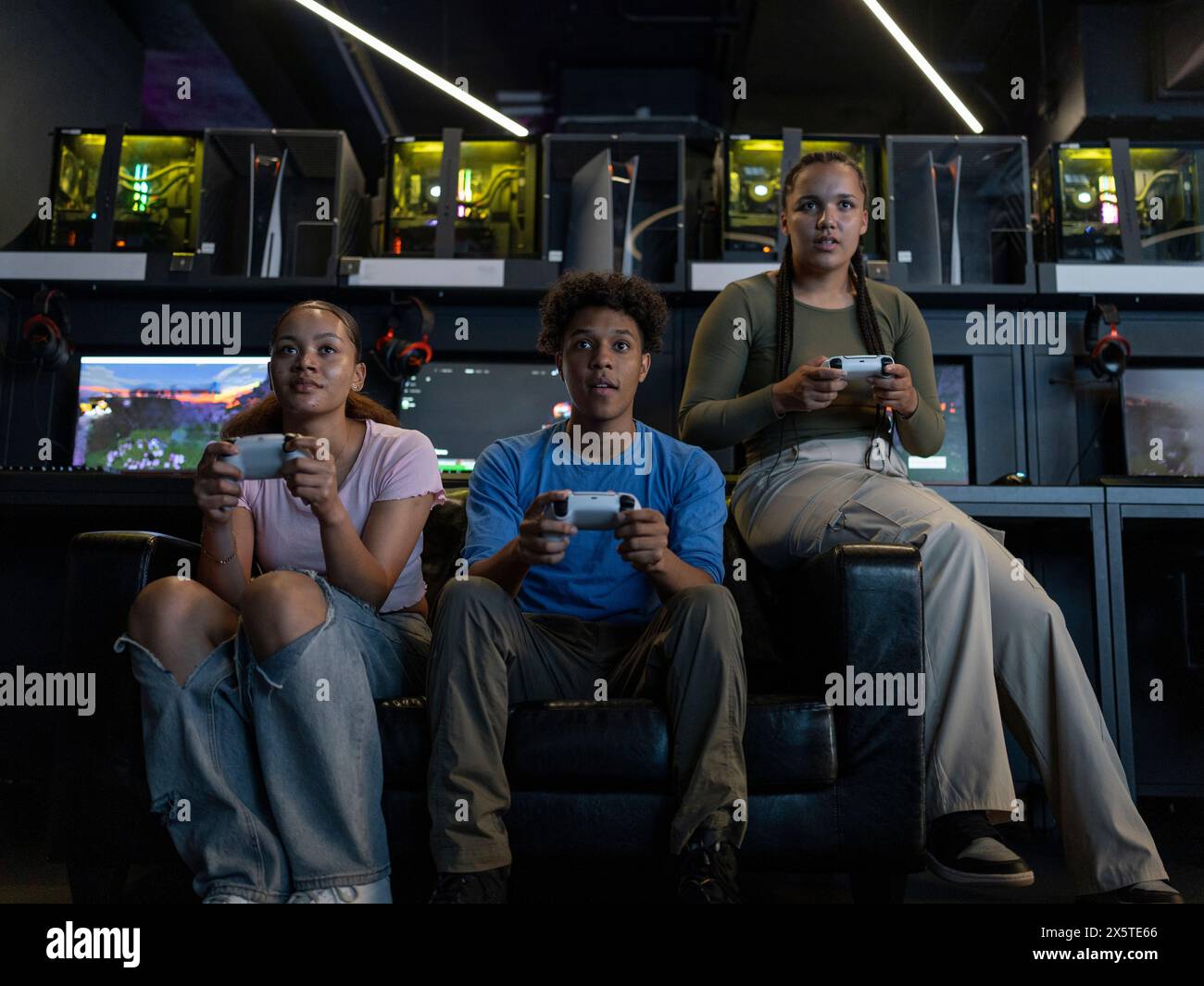 Video game playing friends sofa hi-res stock photography and images - Alamy
