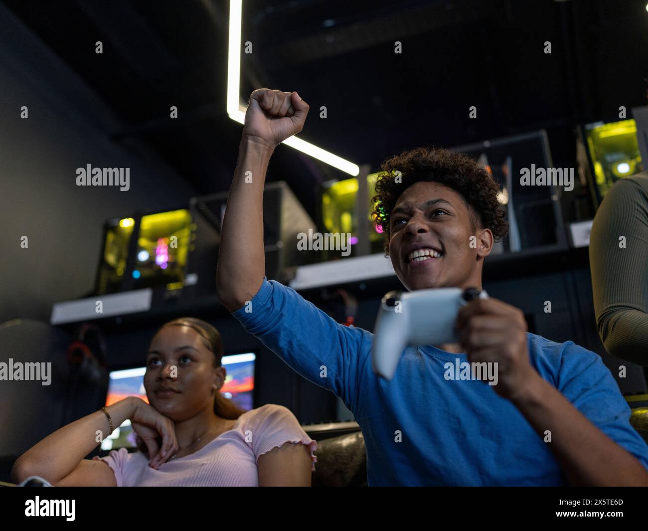 Excited man playing video games with friend in gaming club Stock Photo ...