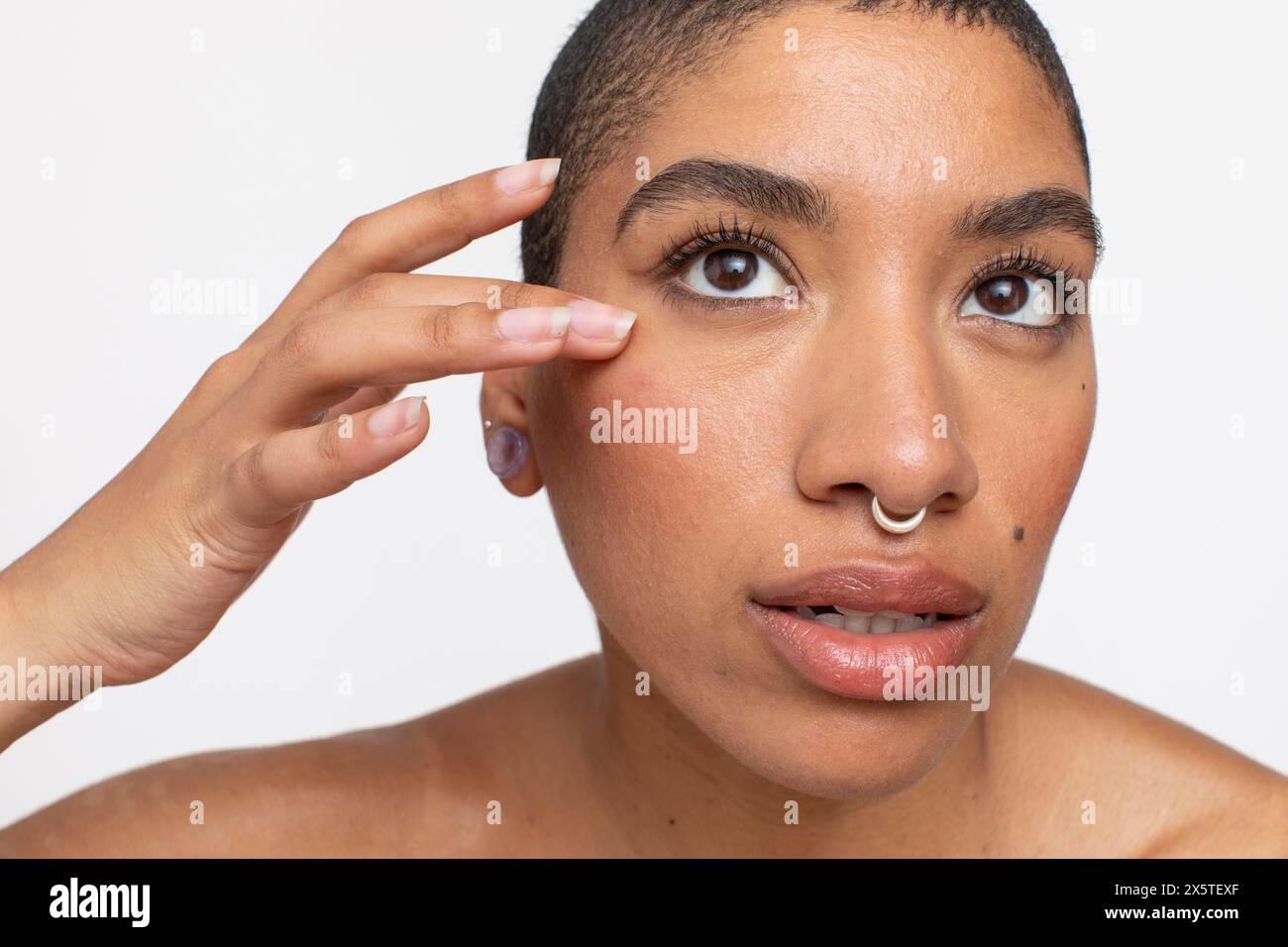 Woman finger touching nose hi-res stock photography and images - Alamy